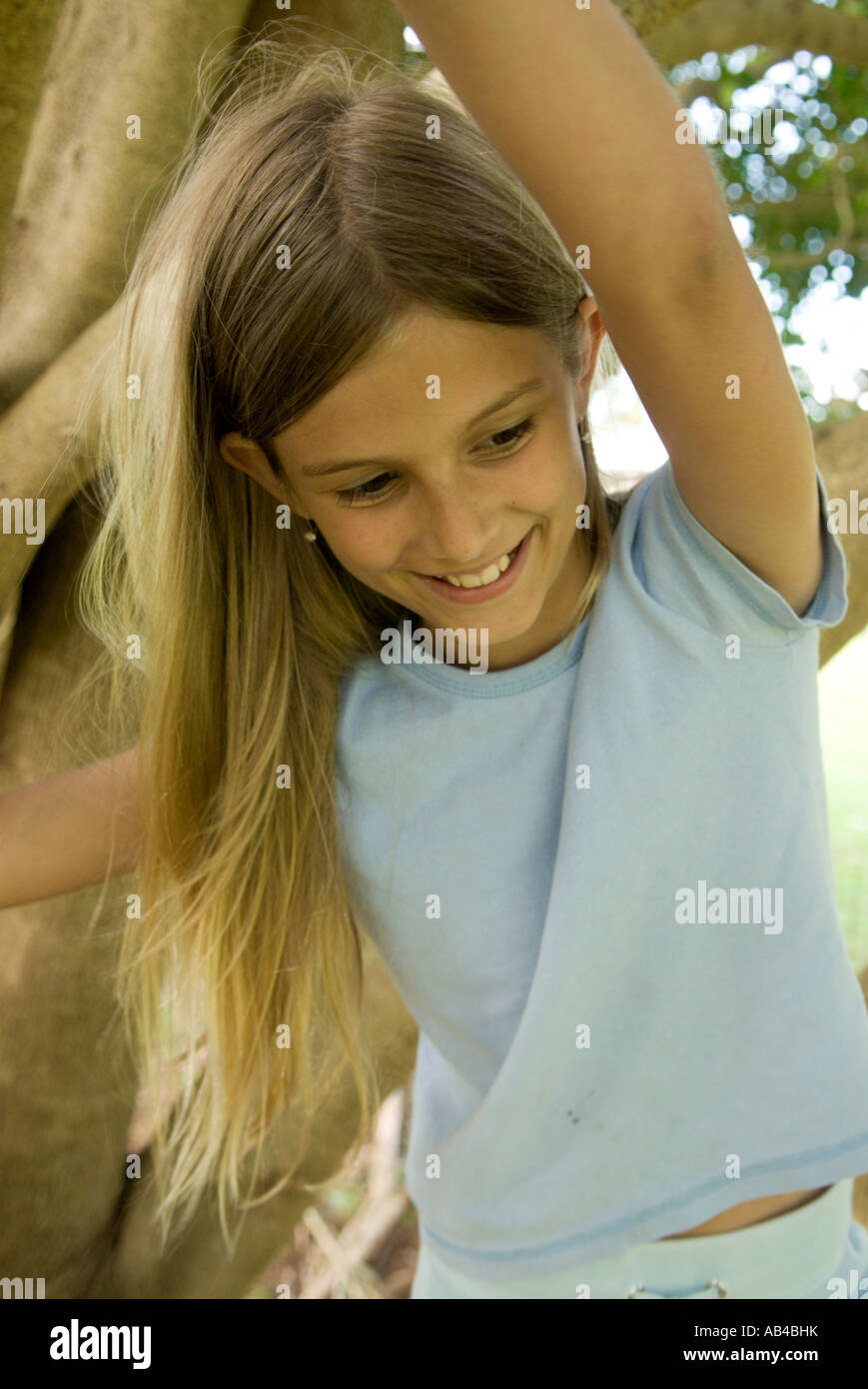 9 year old girl playing in tree Stock Photo - Alamy