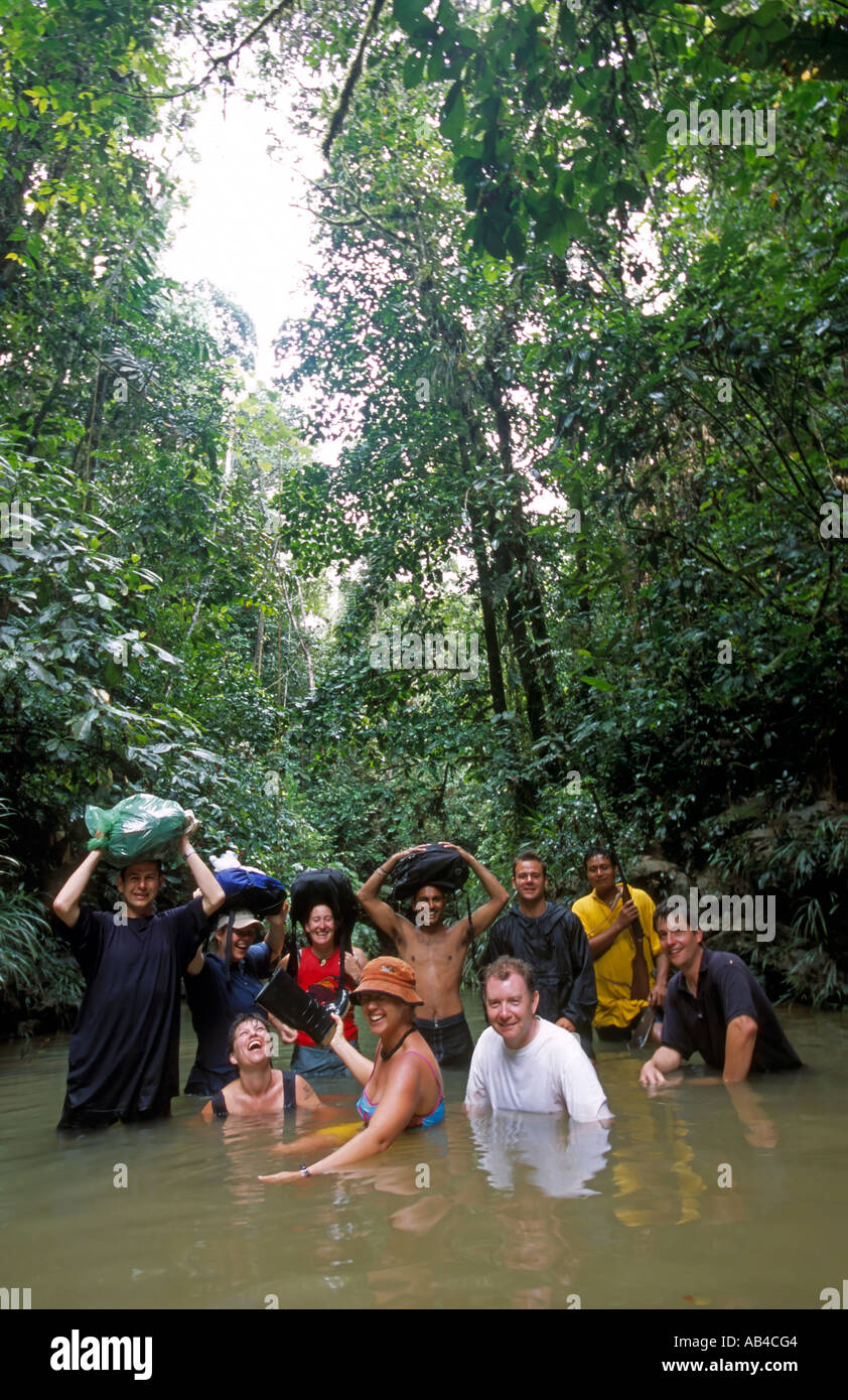 A group of tourists pose for the camera in the Ecuadorian Amazon ...