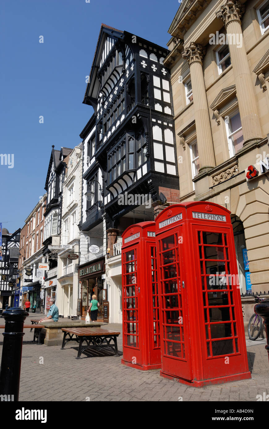 Chester. Traditional red British phone boxes and black and white half ...