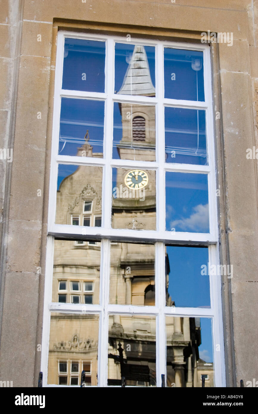 Building with clock tower reflected in window of Georgian town house in ...