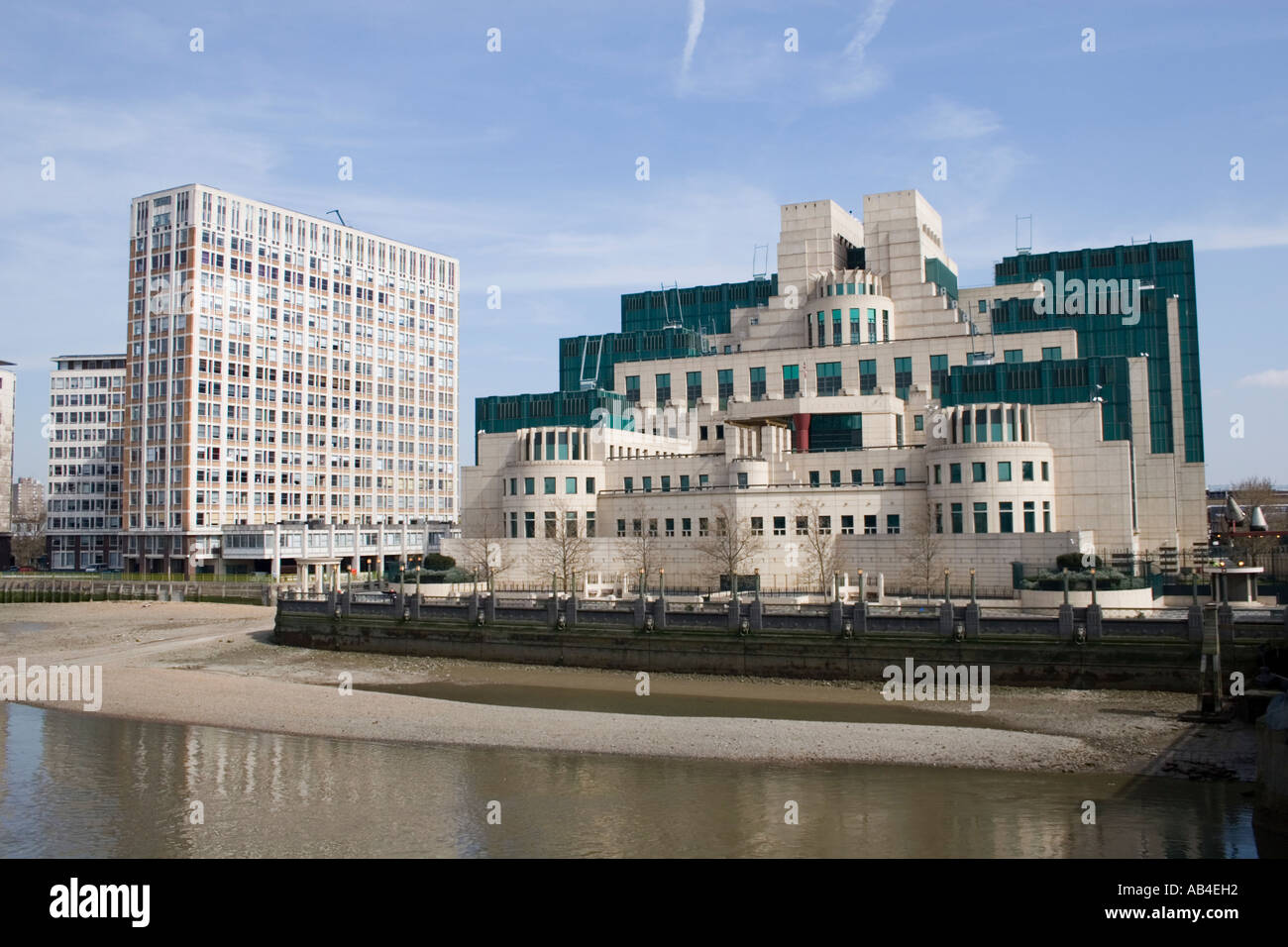 View of the iconic MI6 building by the River Thames at low tide, London ...