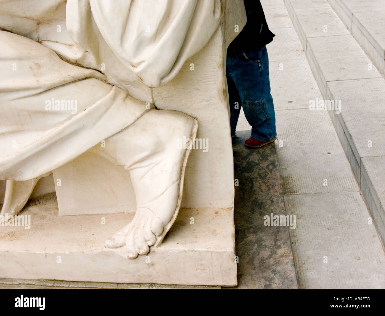 A statue's foot dwarf's a toddler's foot in background Stock Photo - Alamy