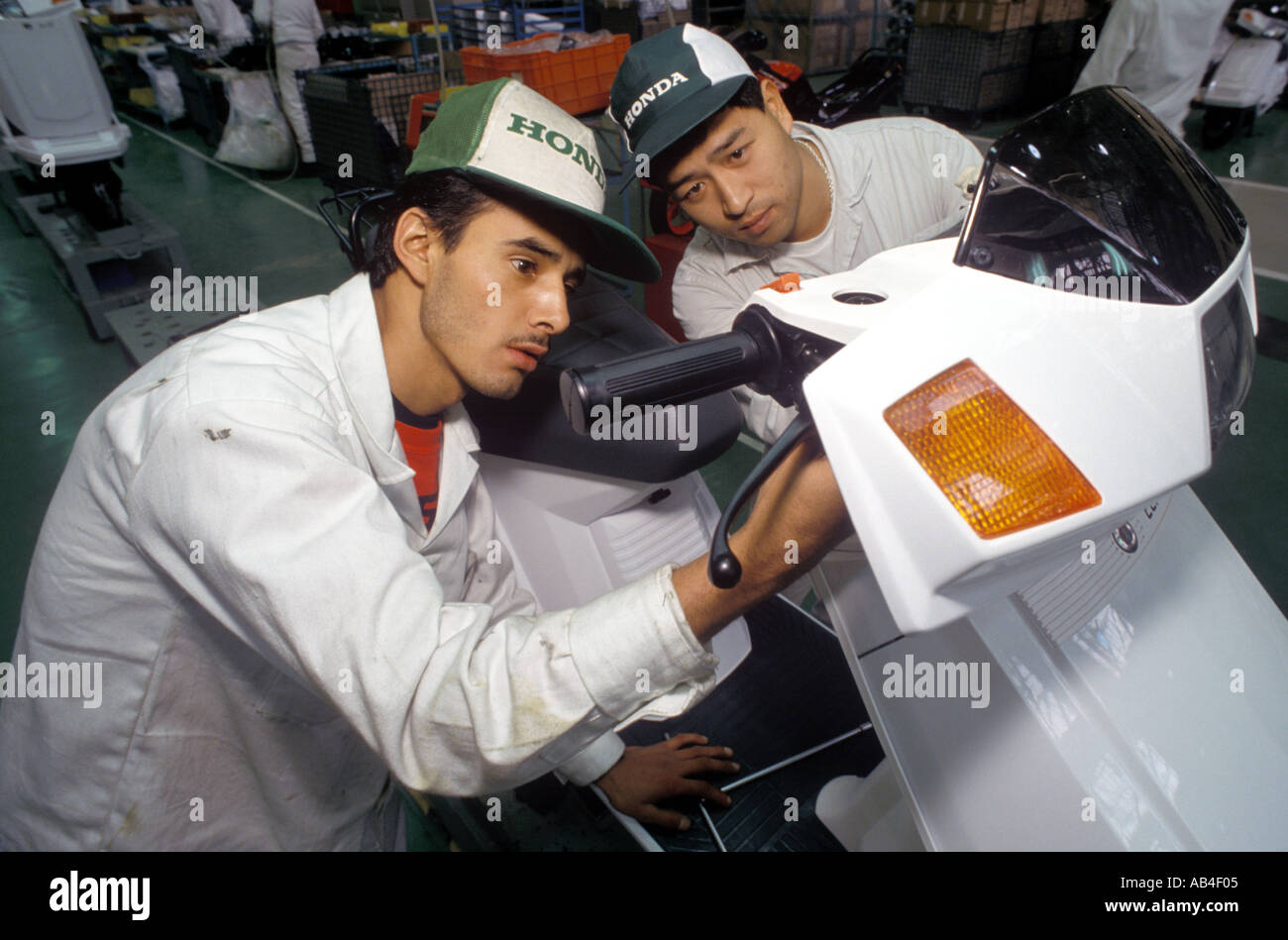 A Mexican laborer and his Japonese supervisor working on the assembly ...