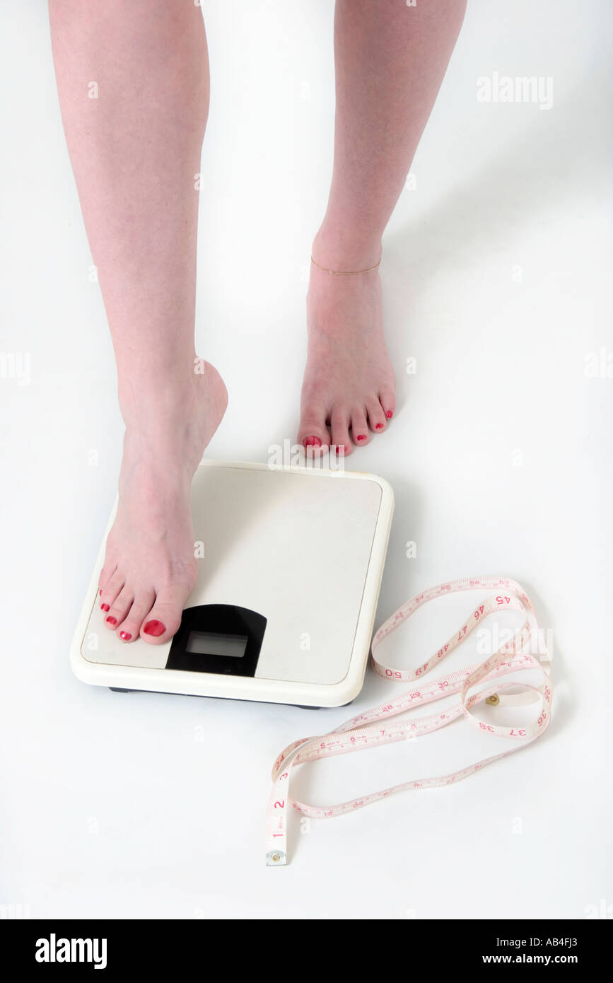 stepping on the scale Stock Photo - Alamy