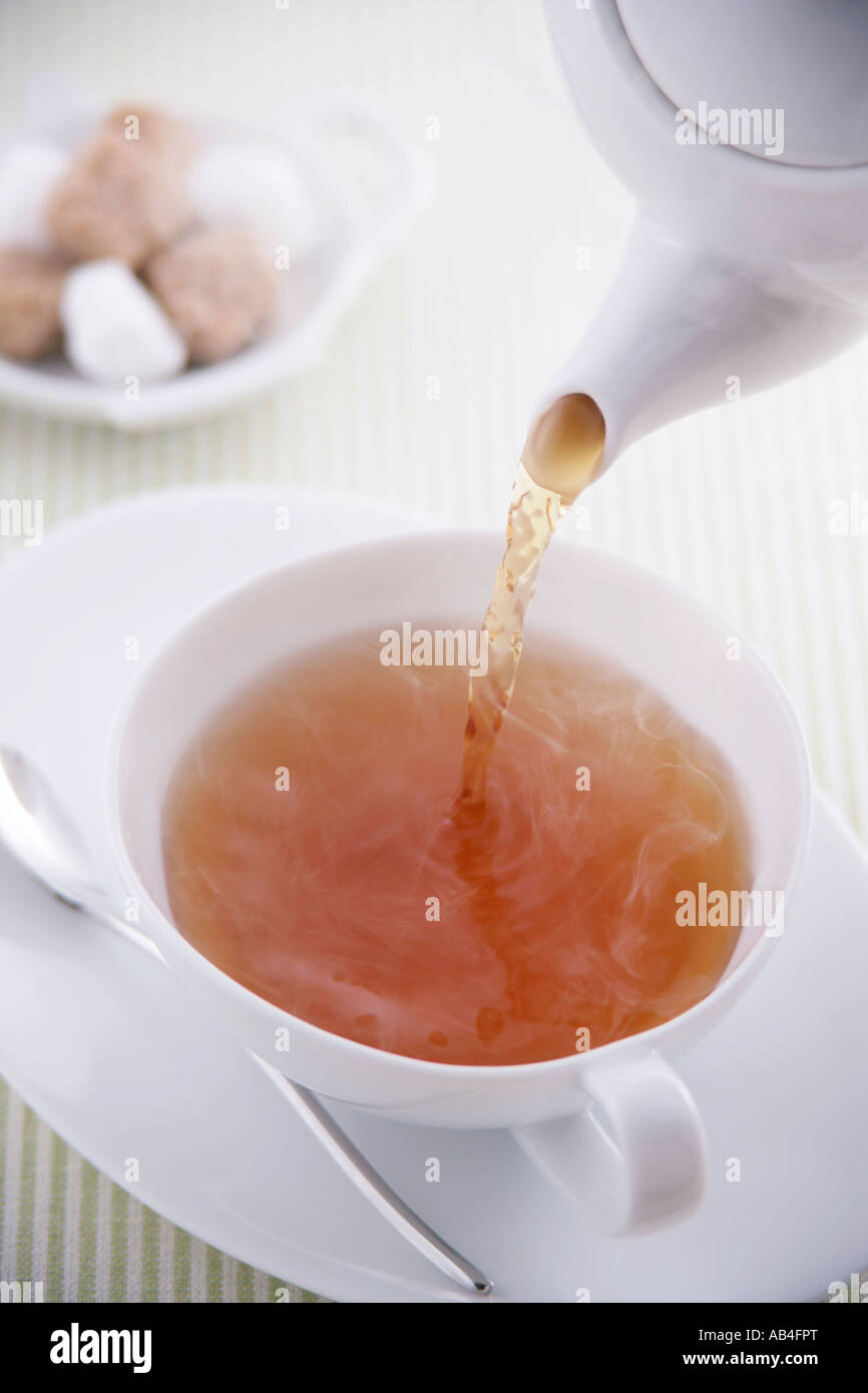 Tea pouring into tea cup Stock Photo - Alamy