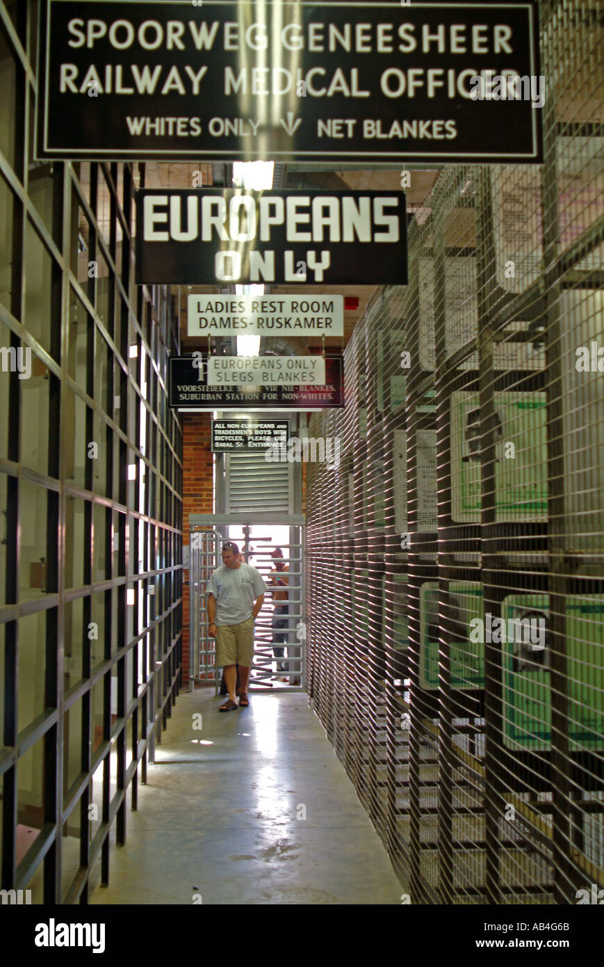 A white man walks through the Europeans only section of the Apartheid ...