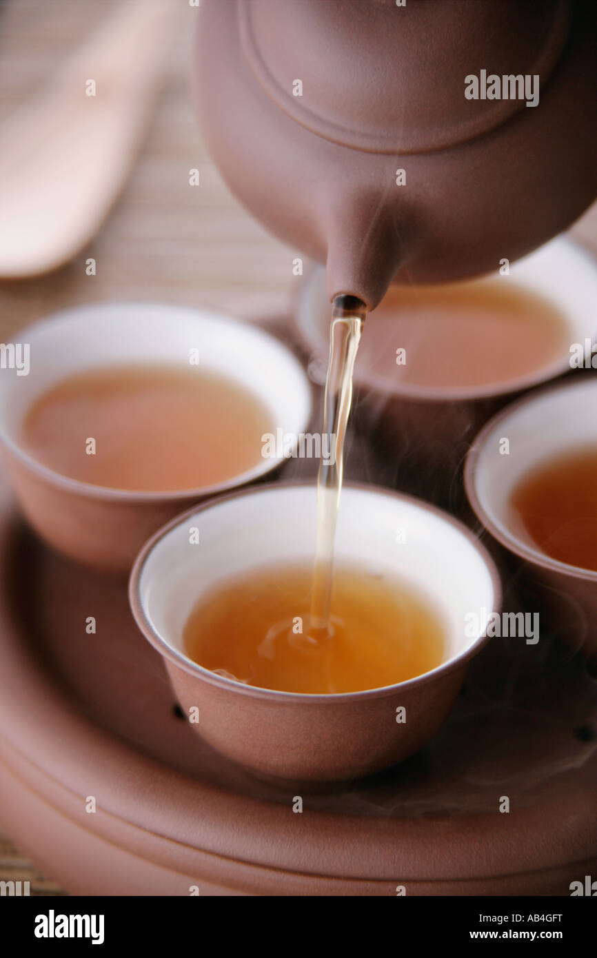 Tea pouring into tea cup Stock Photo - Alamy