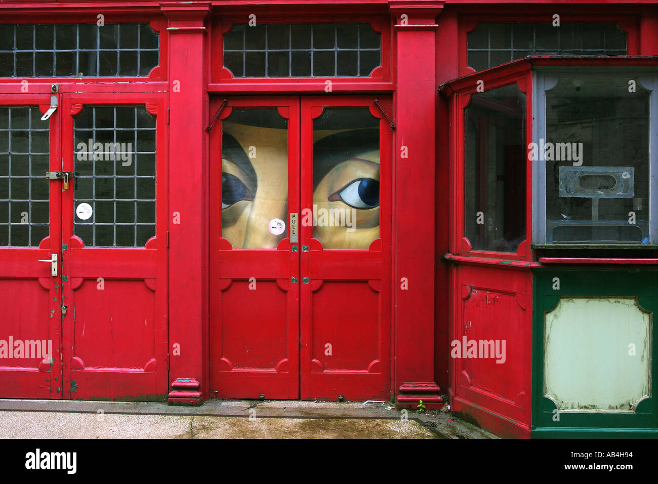 A poster of eyes looks through windows of an old theatre, Bridport ...