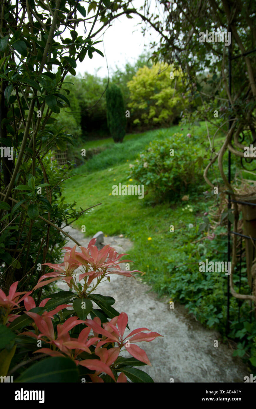 Garden path and archway on a dull Spring day Stock Photo - Alamy