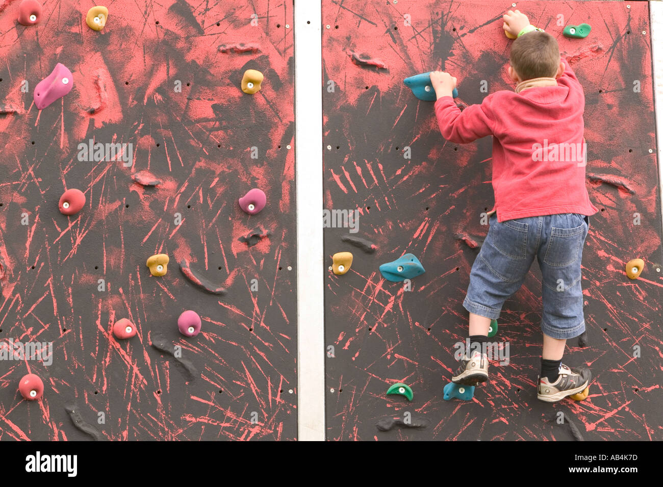 child learning to climb on a climbing wall Stock Photo - Alamy