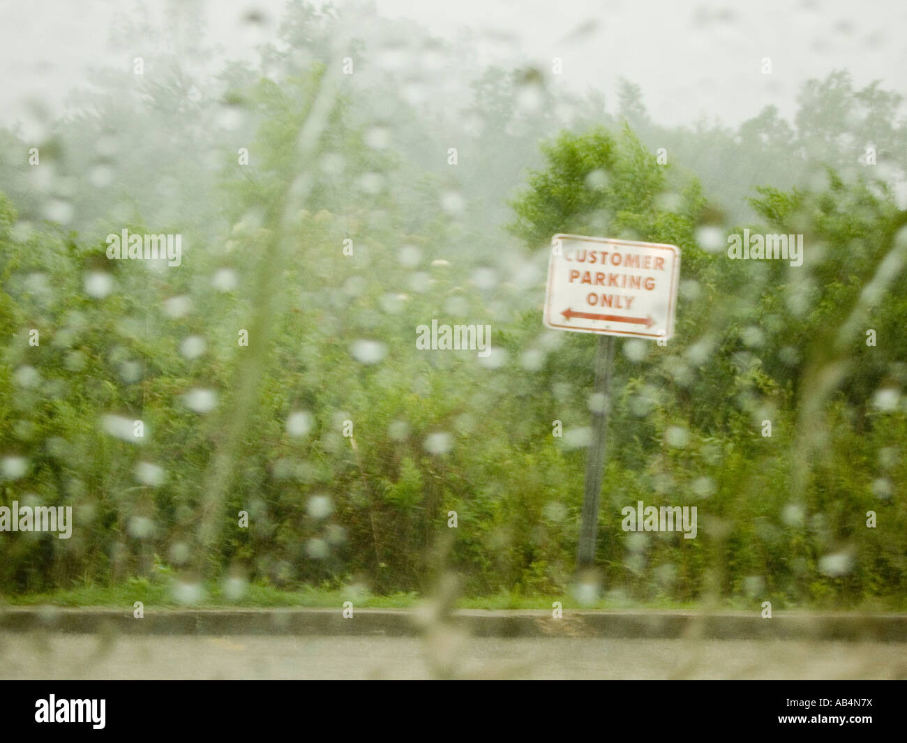 Customer parking sign through rain soaked window Stock Photo - Alamy