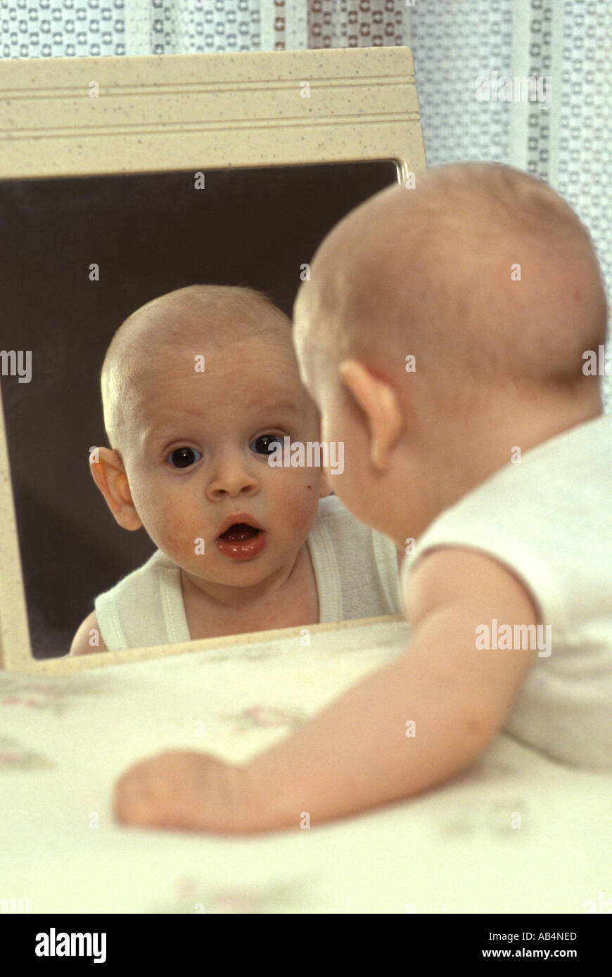 baby discovering his reflection in the mirror Stock Photo - Alamy