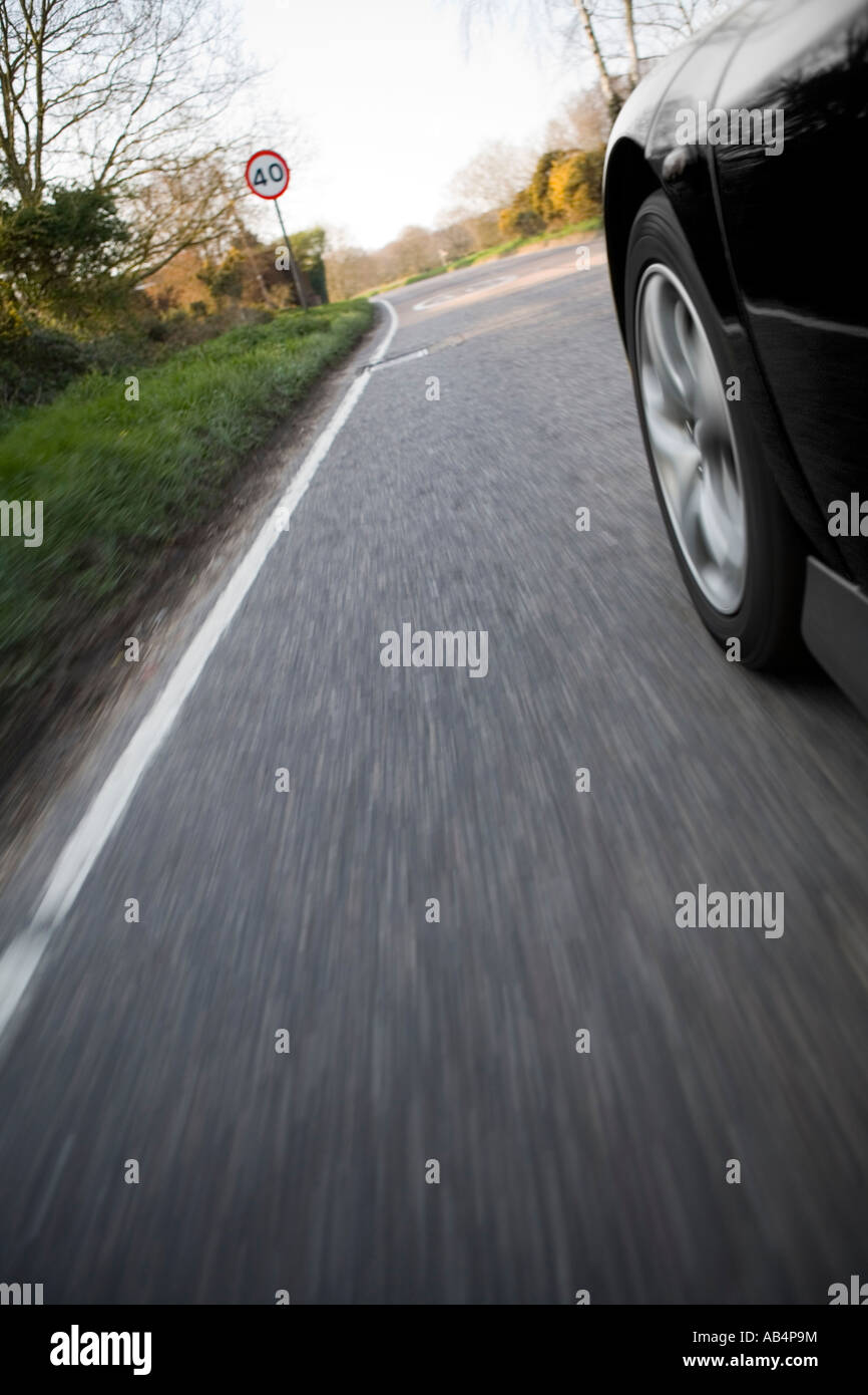country road with a side of black sports car driving along can see sigh ...