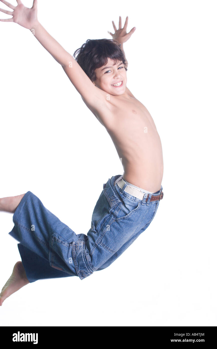 Young boy jumping Studio shot isolated on white background Stock Photo ...