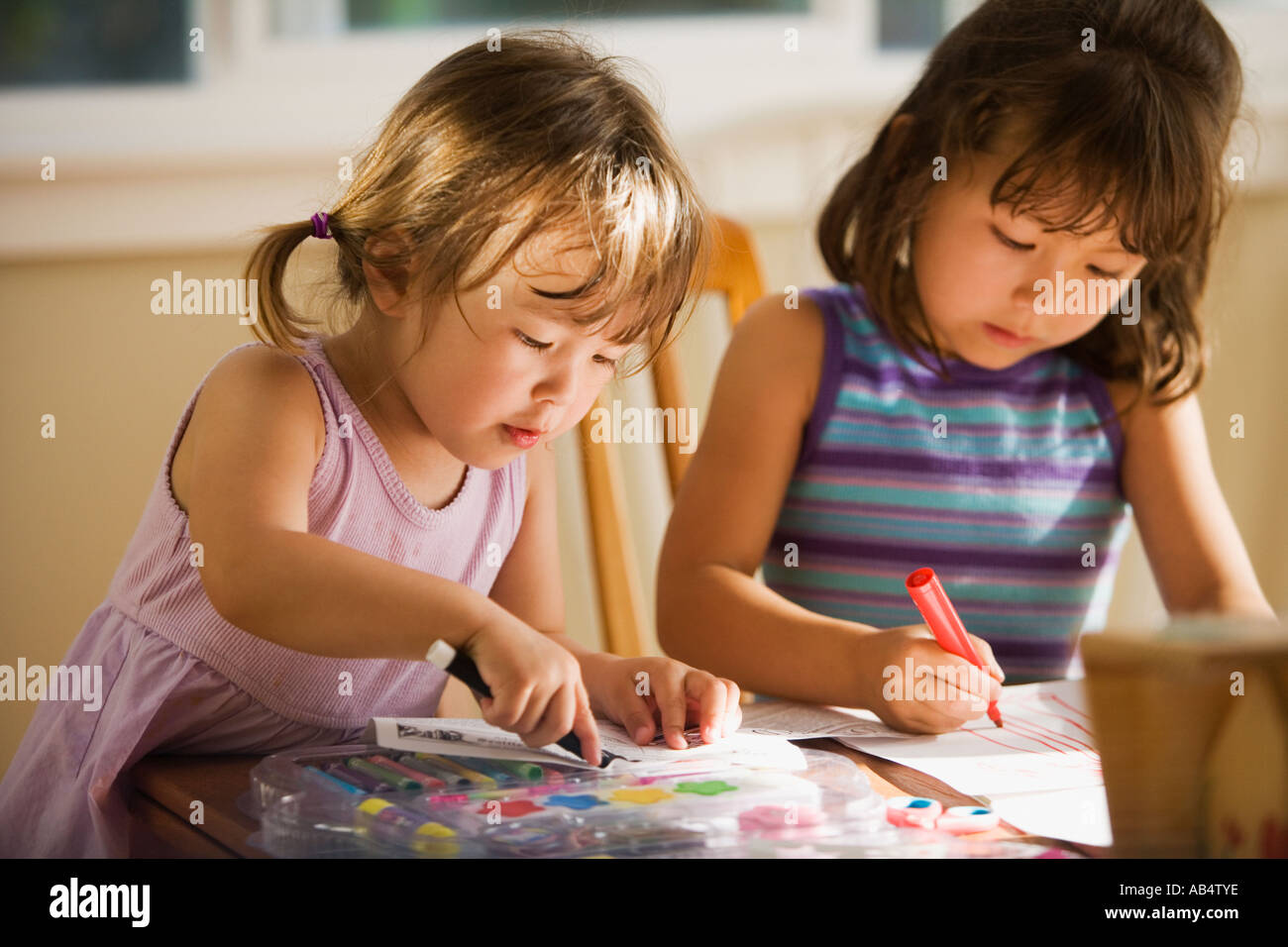 Two girls coloring Stock Photo - Alamy