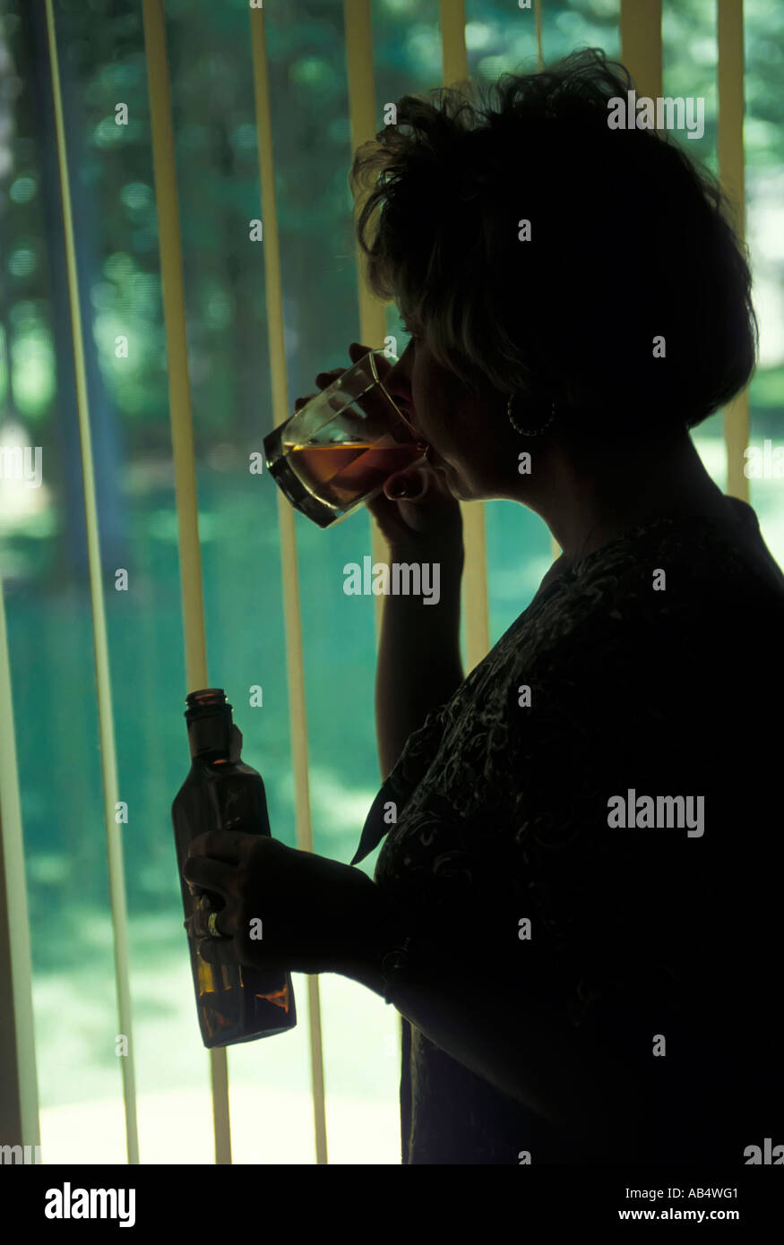 Adult female alcoholic drinks whisky at home during daytime hours Stock ...