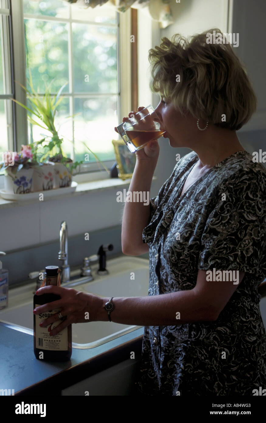 Adult female alcoholic drinks whisky at home during daytime hours Stock ...