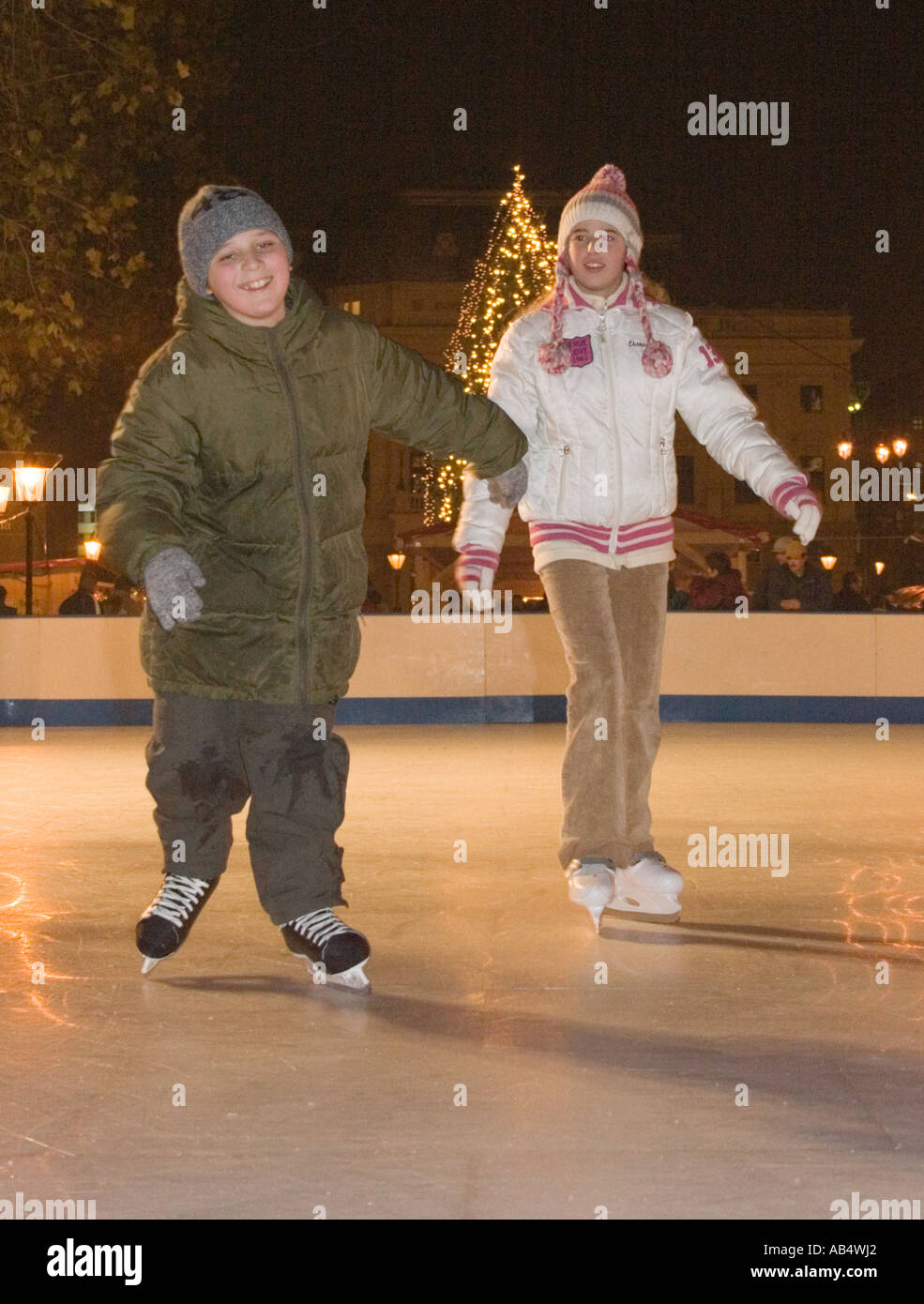 Boy and girl children ice skating hi-res stock photography and images ...