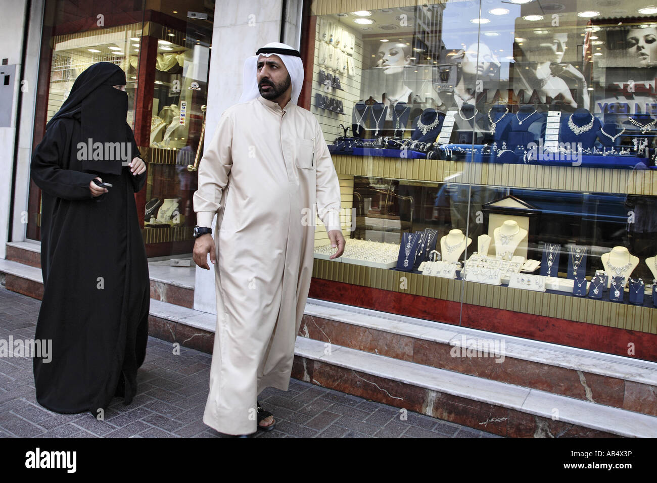 arab couple walking by a jewelry shop, gold souk, Dubai Stock Photo - Alamy