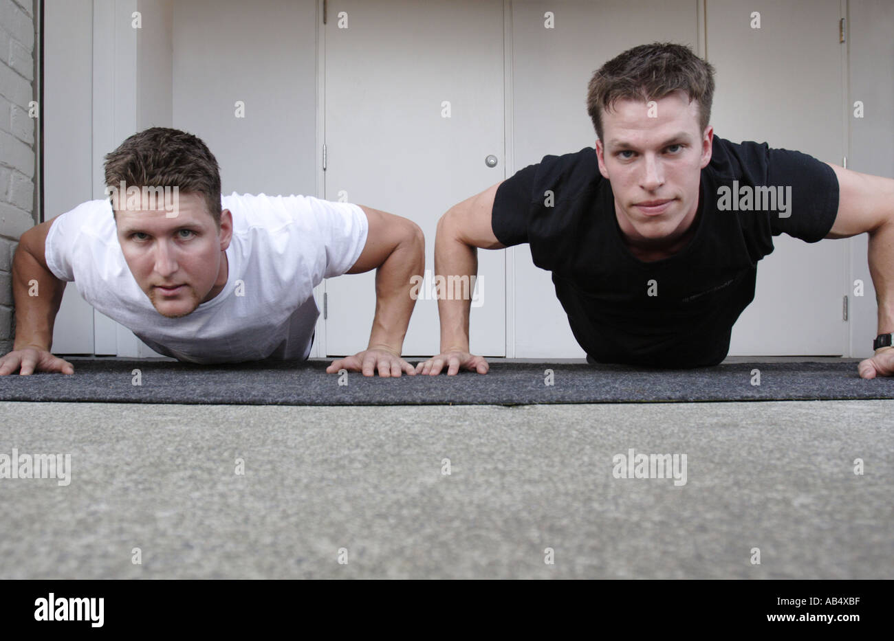 two young men doing pushups Stock Photo - Alamy