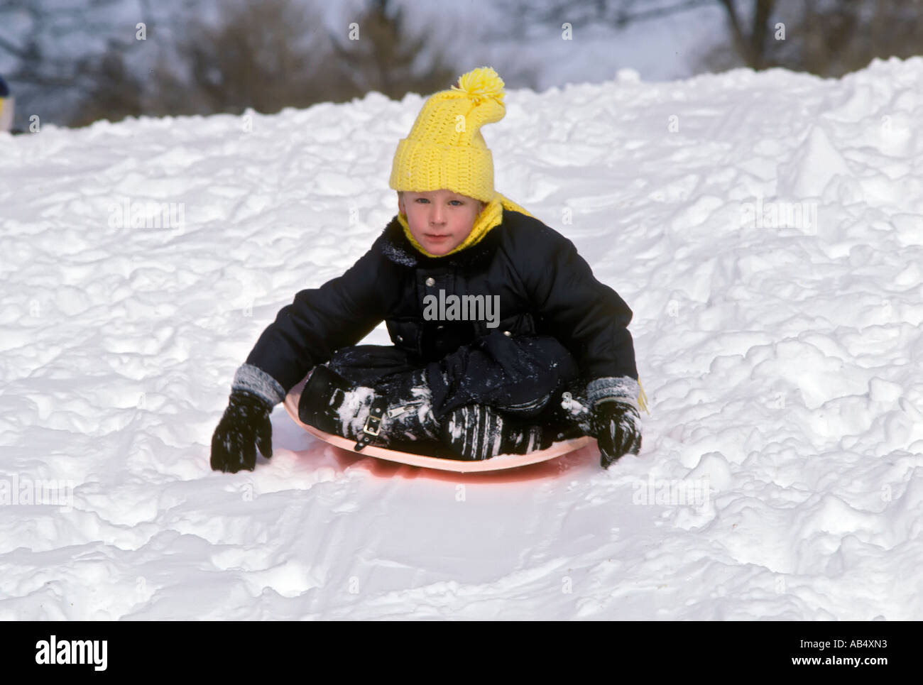 Winter snow activities with children playing in the snow and riding a ...