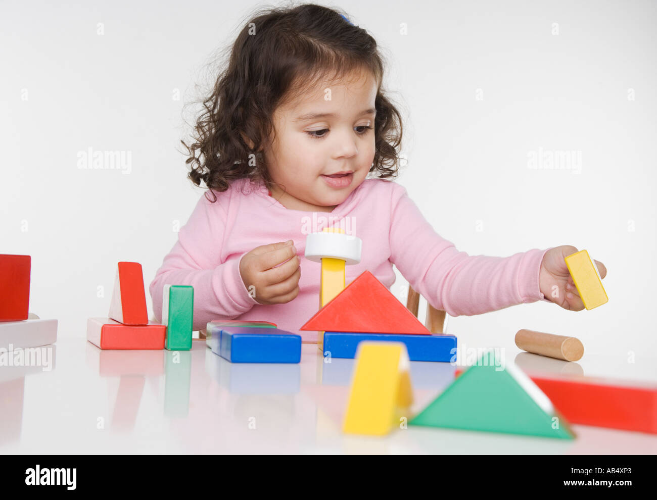 Little girl playing with blocks Stock Photo - Alamy