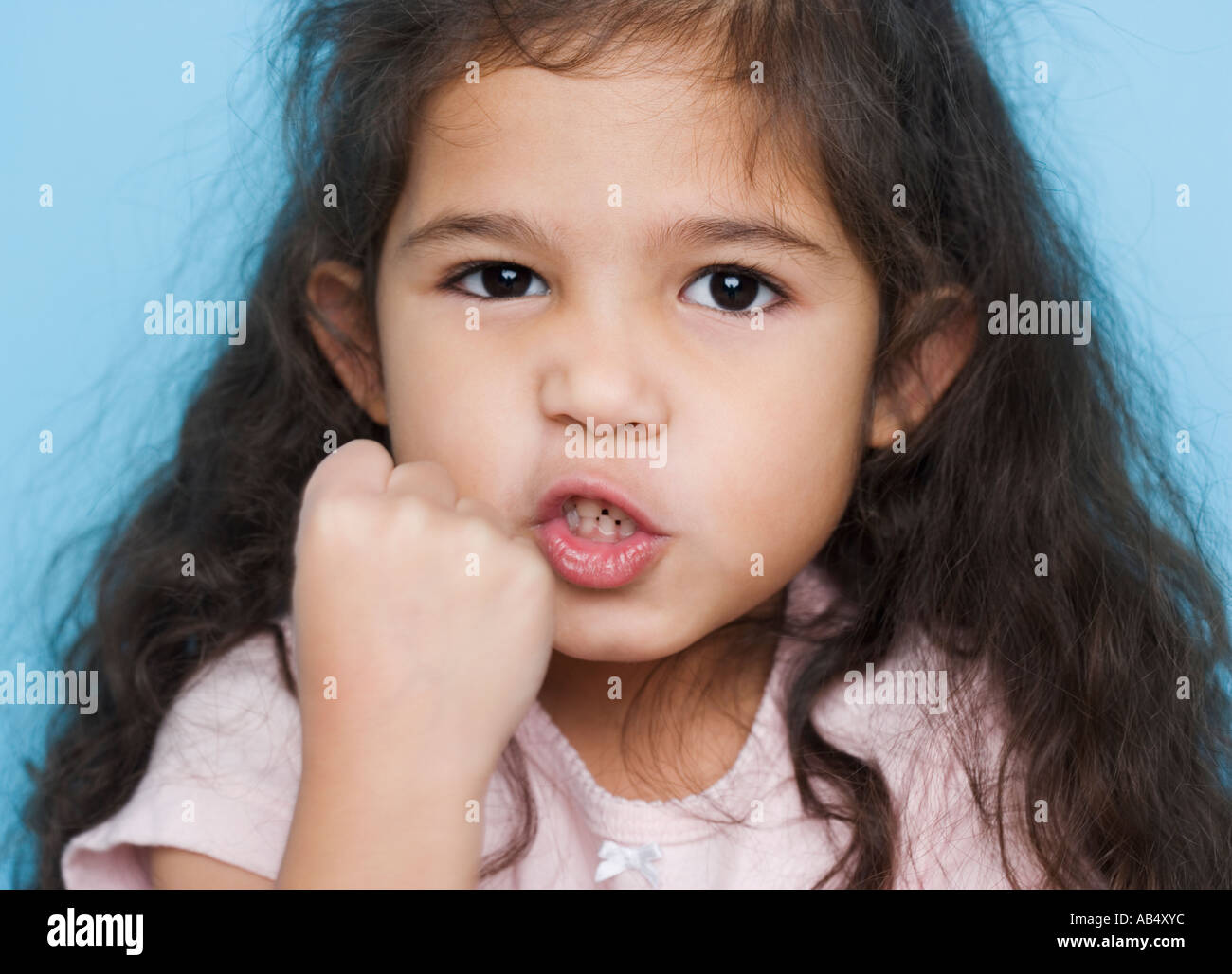 Portrait of girl making fist Stock Photo - Alamy