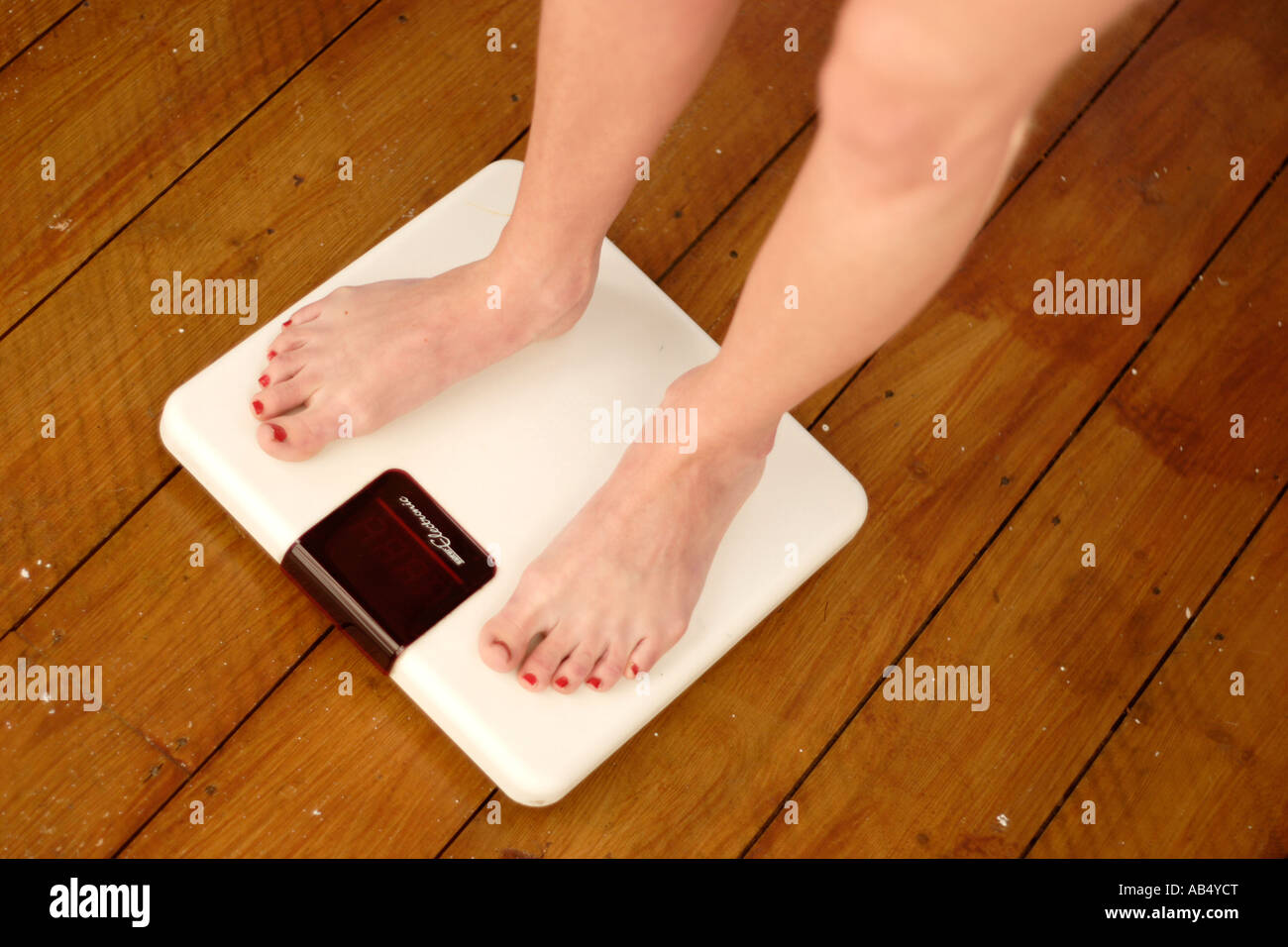 young woman getting weighed Stock Photo - Alamy