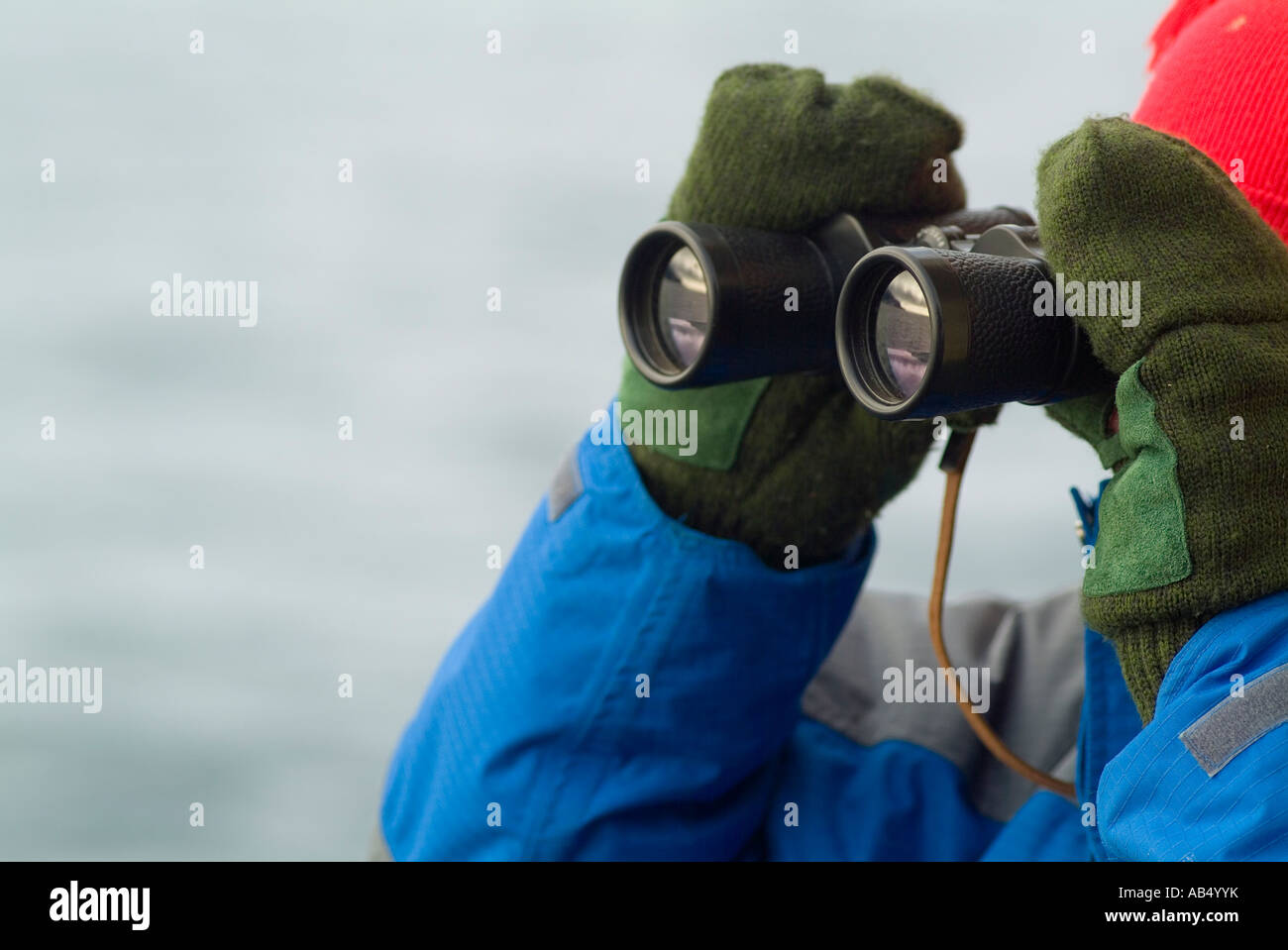 Man on cruise keeping watch with binoculars Stock Photo - Alamy