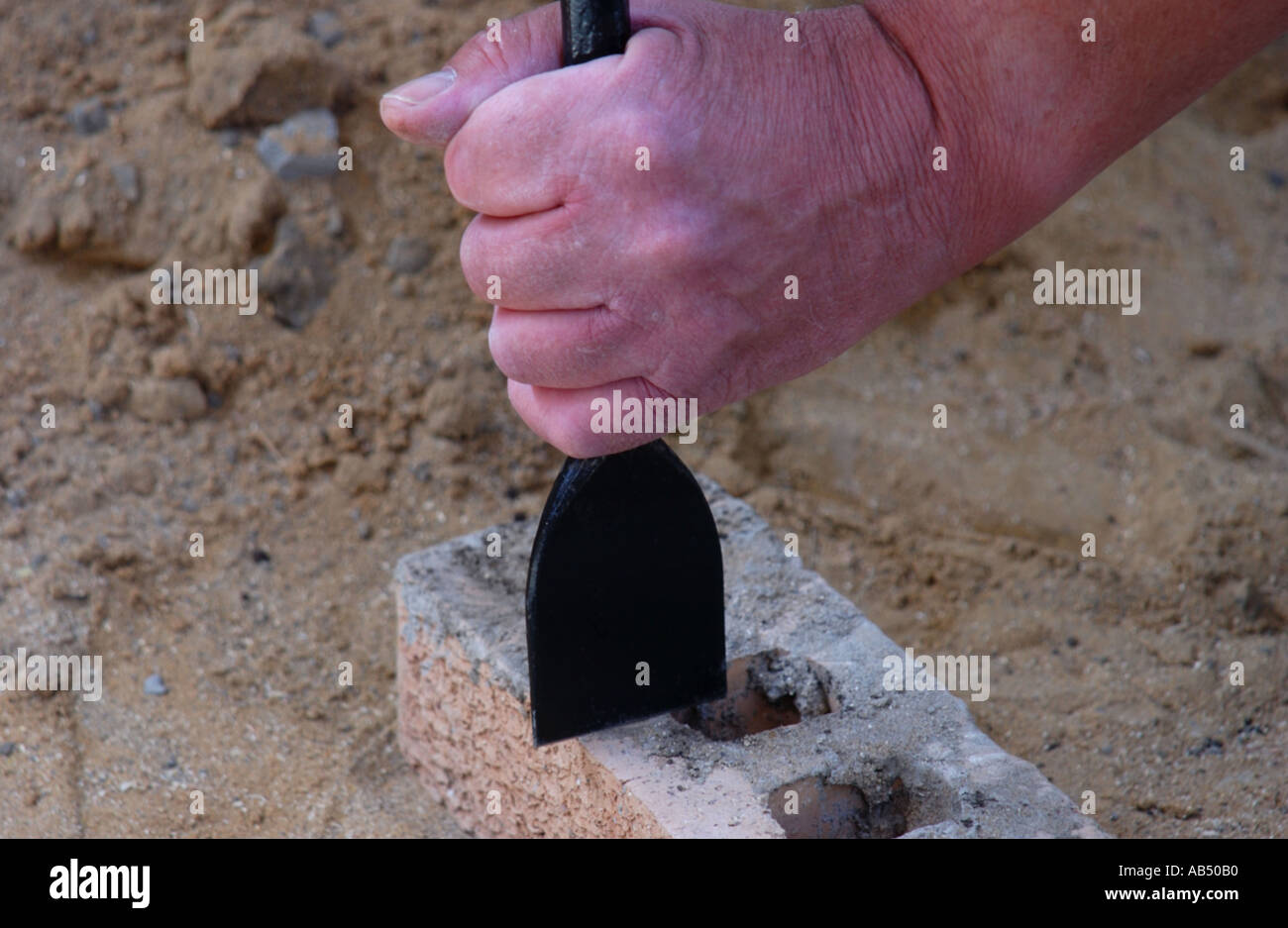 hand holding chisel and hammer Stock Photo - Alamy