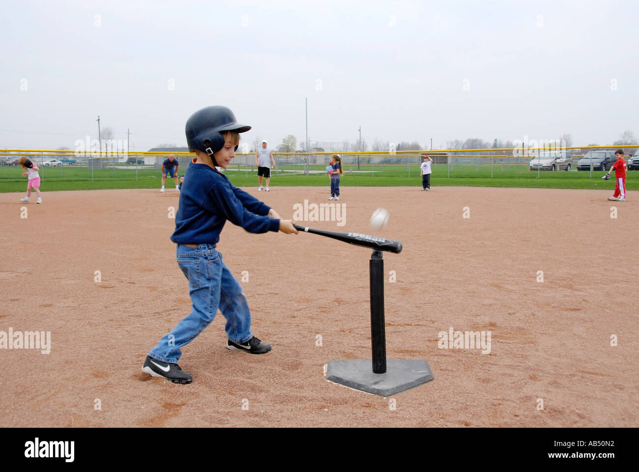 5 year old boys and girls learn how to play baseball by participating ...