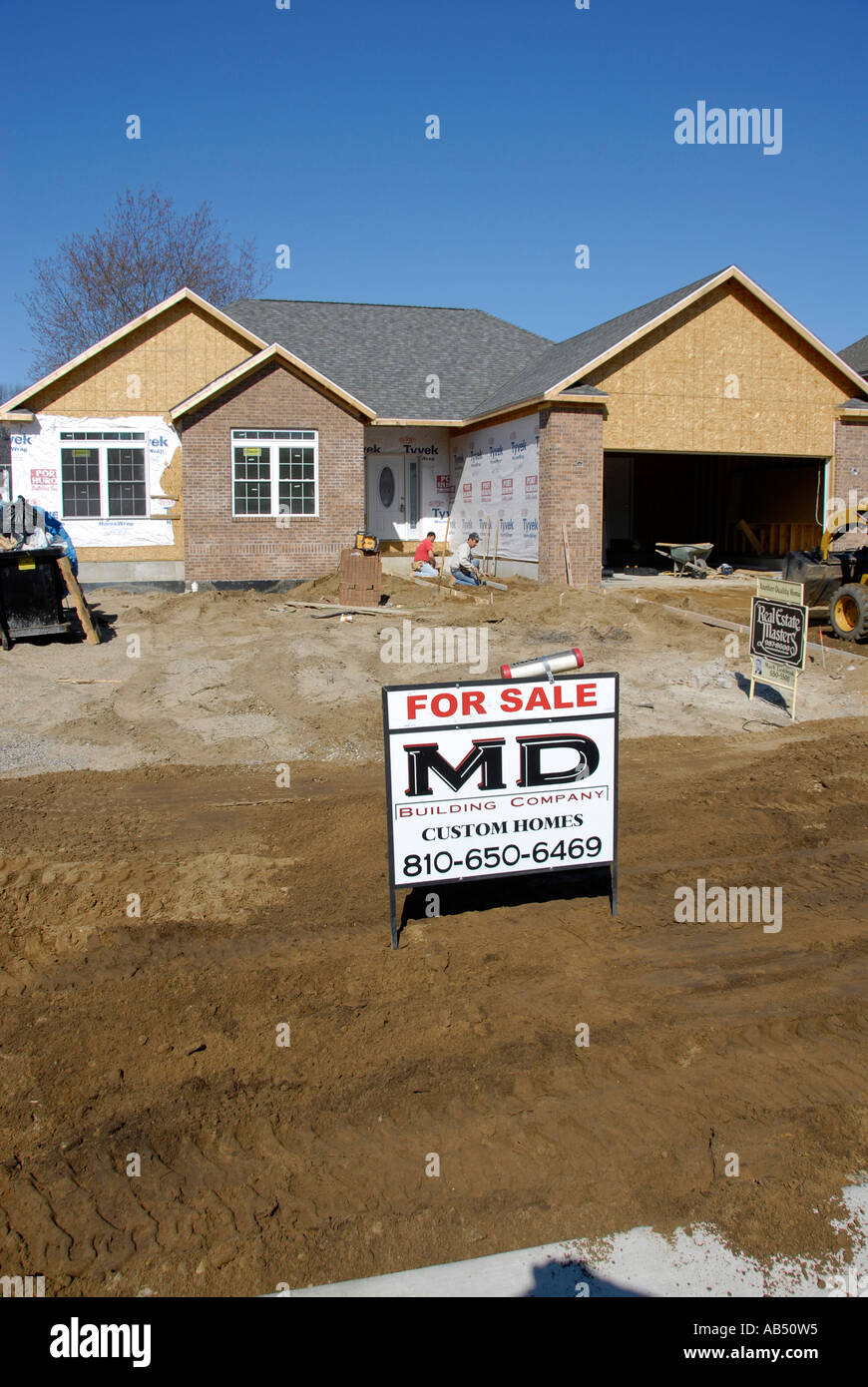 New home construction with builders sign in front of house in a ...