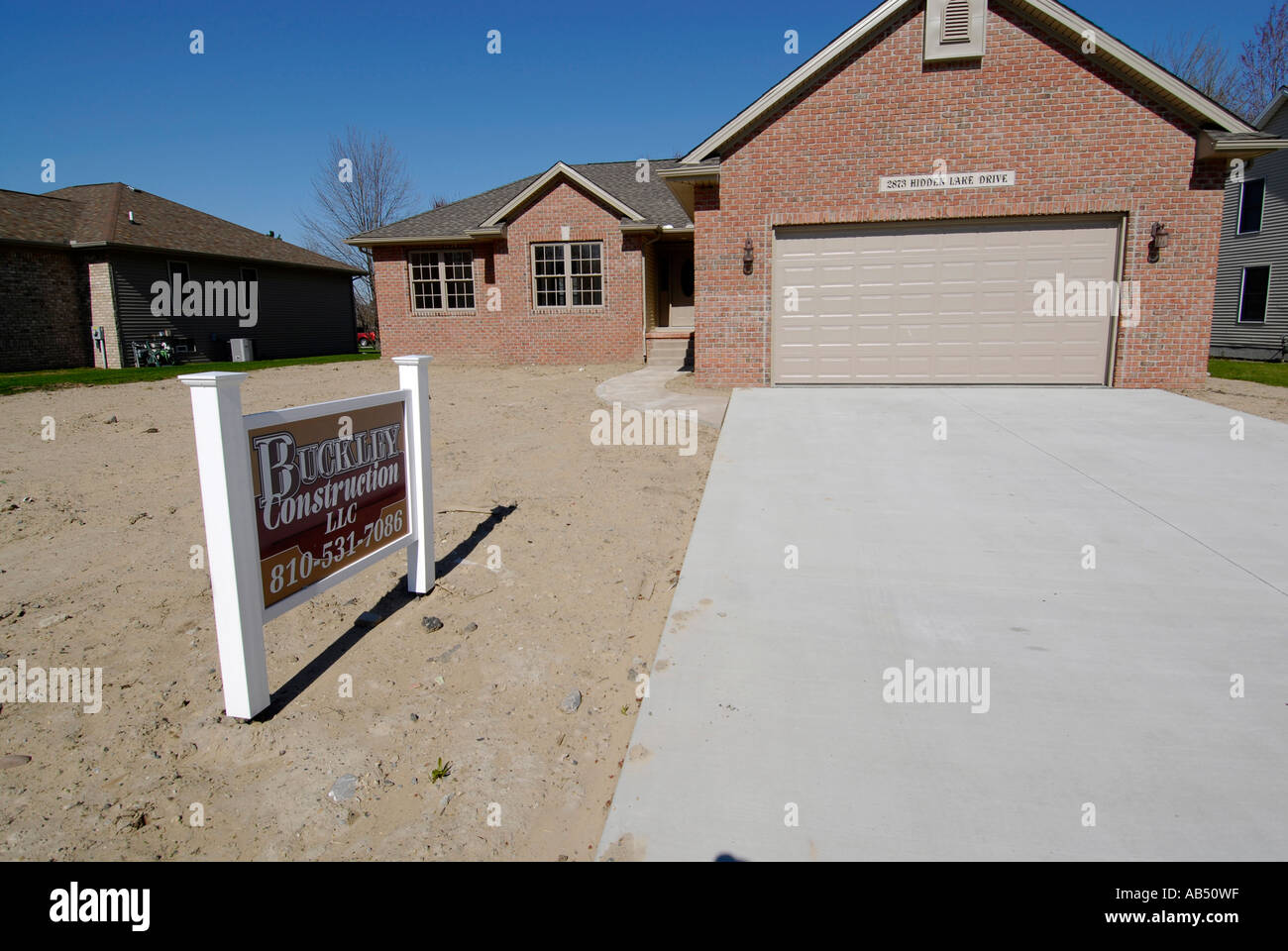New home construction with builders sign in front of house in a ...