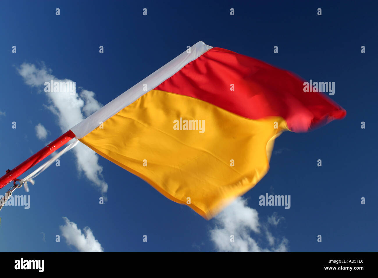 Red and yellow surf flag on Sydney s Bondi beach set against a deep ...