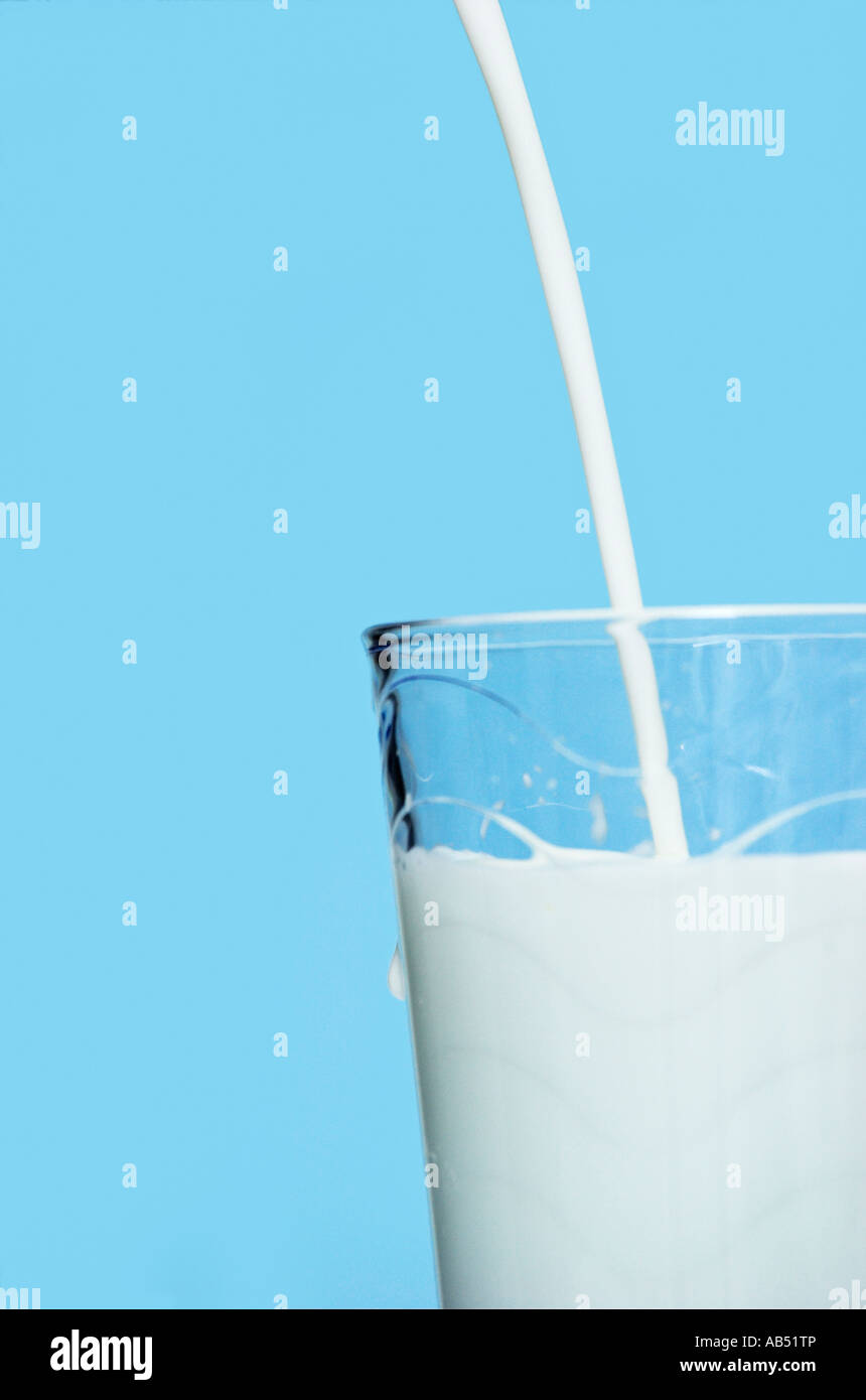 Pouring milk into glass Stock Photo - Alamy