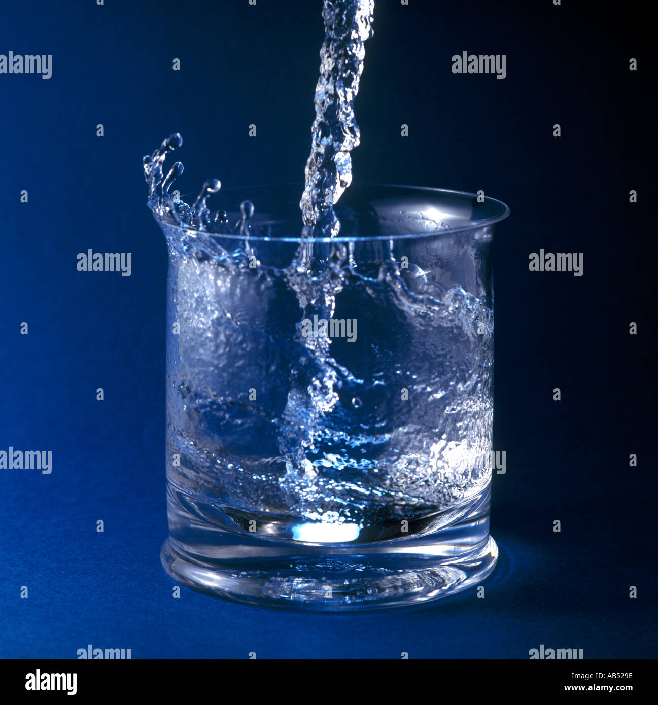 Water pouring in to a glass Stock Photo - Alamy