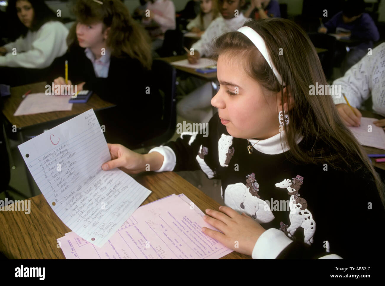 4th grade female student looks at an average grade of C on her paper ...