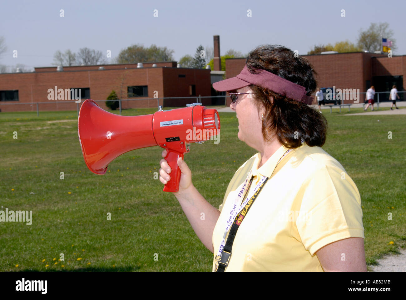 Female coach communicate with team with the use of an amplified ...