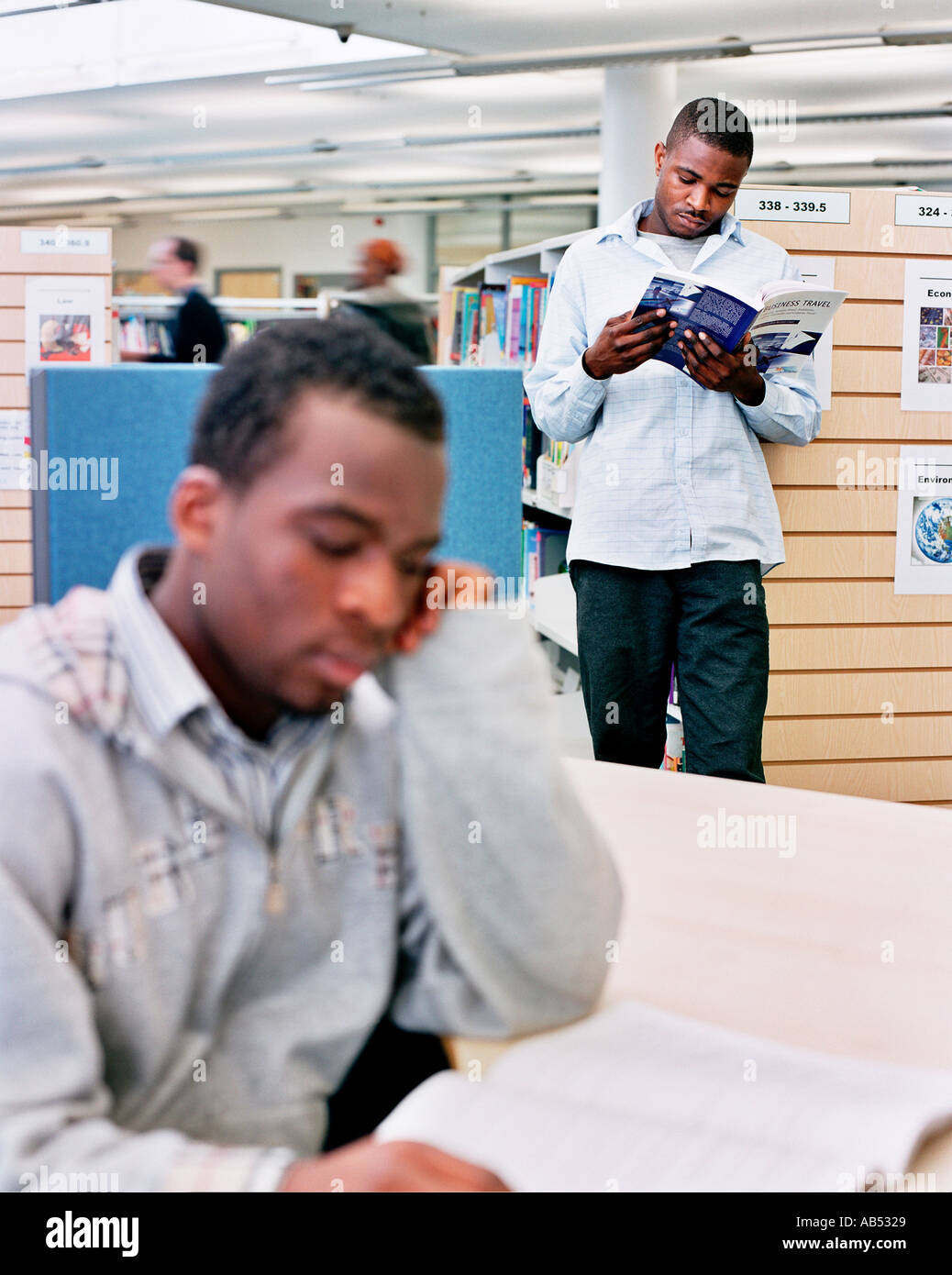 black man reading in library Stock Photo - Alamy