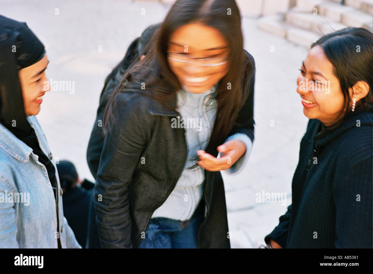 three asian female teenager friends laughing share a joke Stock Photo ...