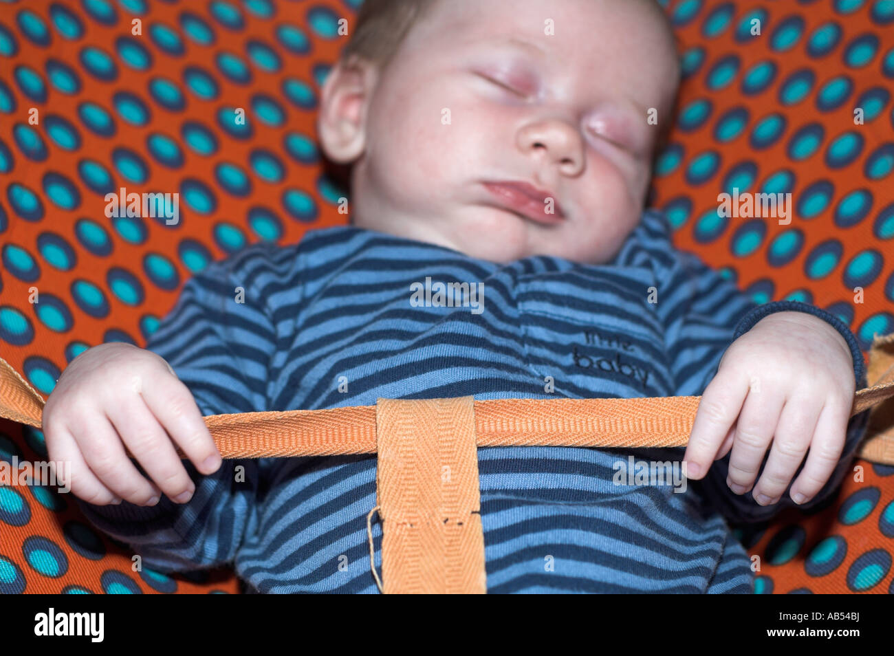 Baby asleep in a baby chair Stock Photo - Alamy