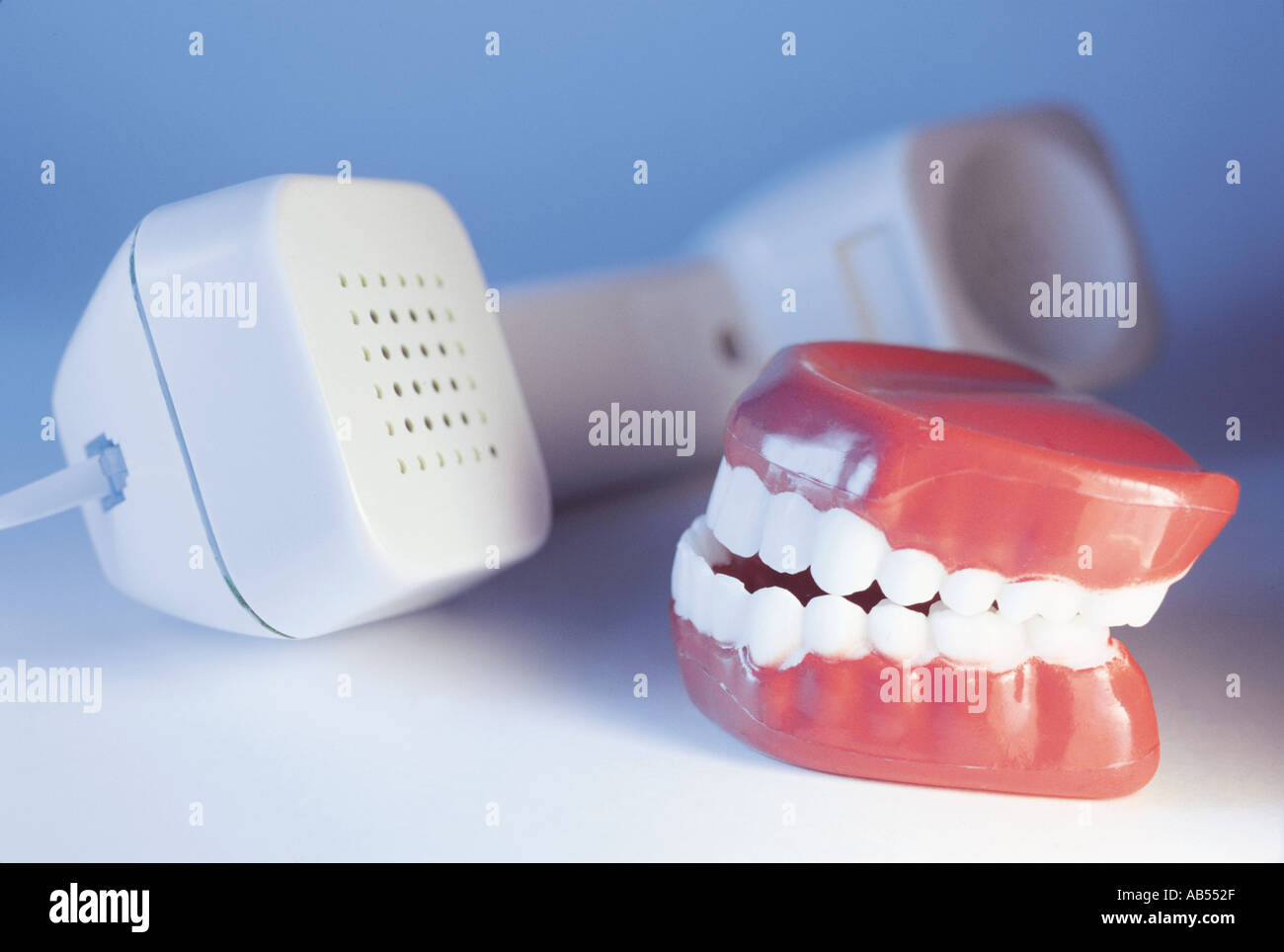 Toy Denture and Phone Handset Stock Photo - Alamy