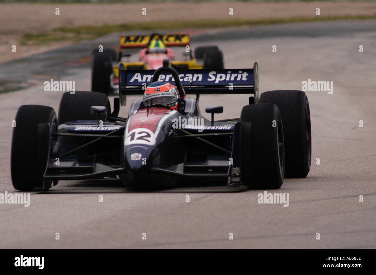 Jimmy Vasser followed by 4 other cars at the Grand Prix of Road Amrica ...