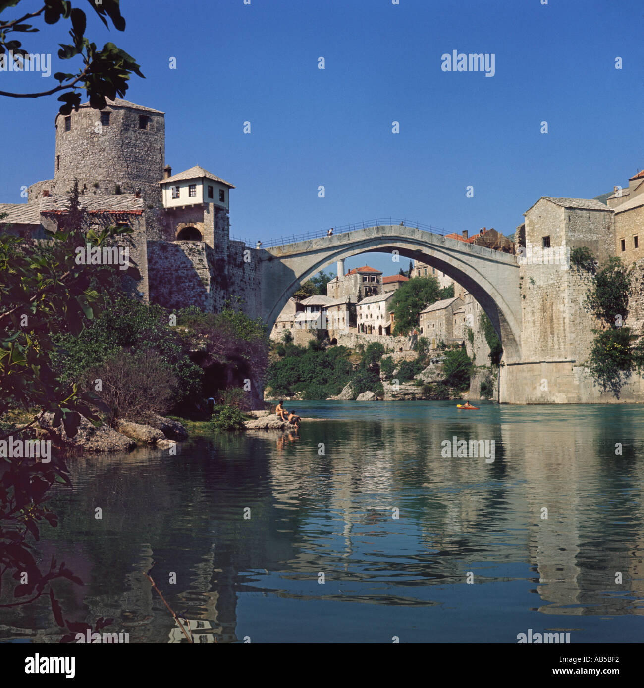 The classic original old arched stone built bridge with ancient watch ...