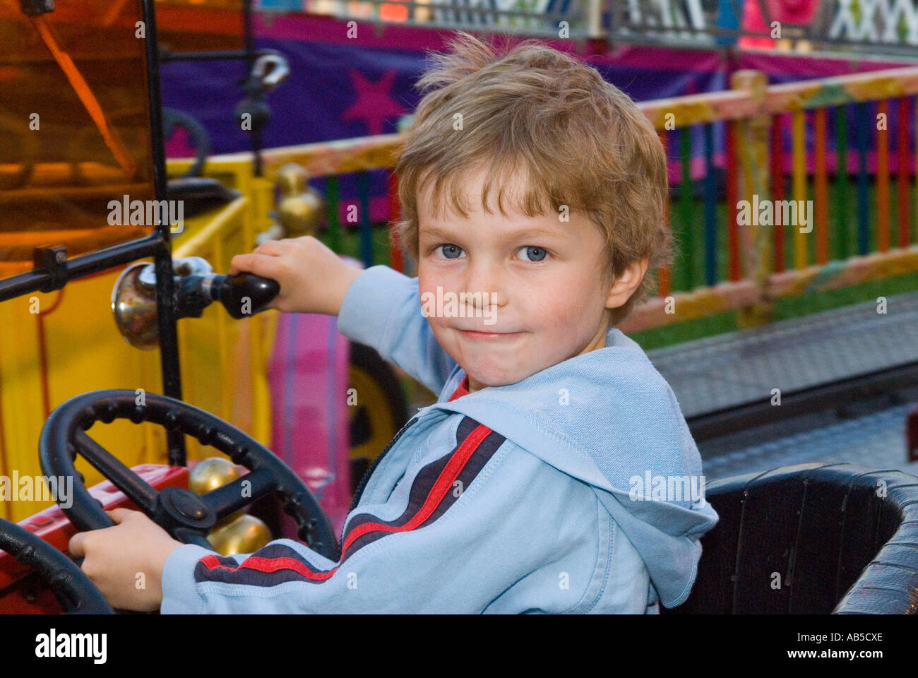 Young child having fun on fairground ride Stock Photo - Alamy