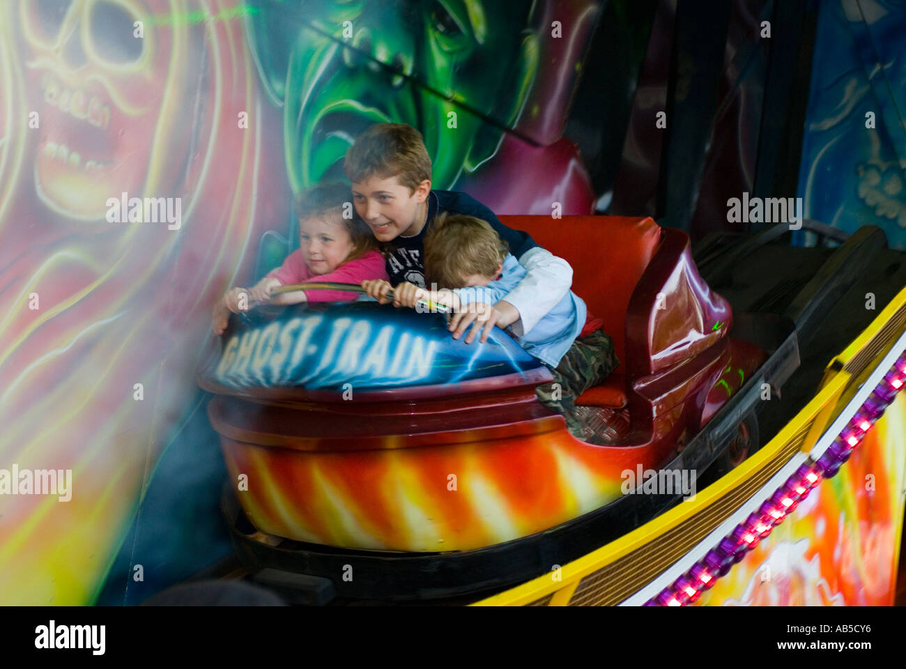 Young children on ghost train fairground ride Stock Photo - Alamy