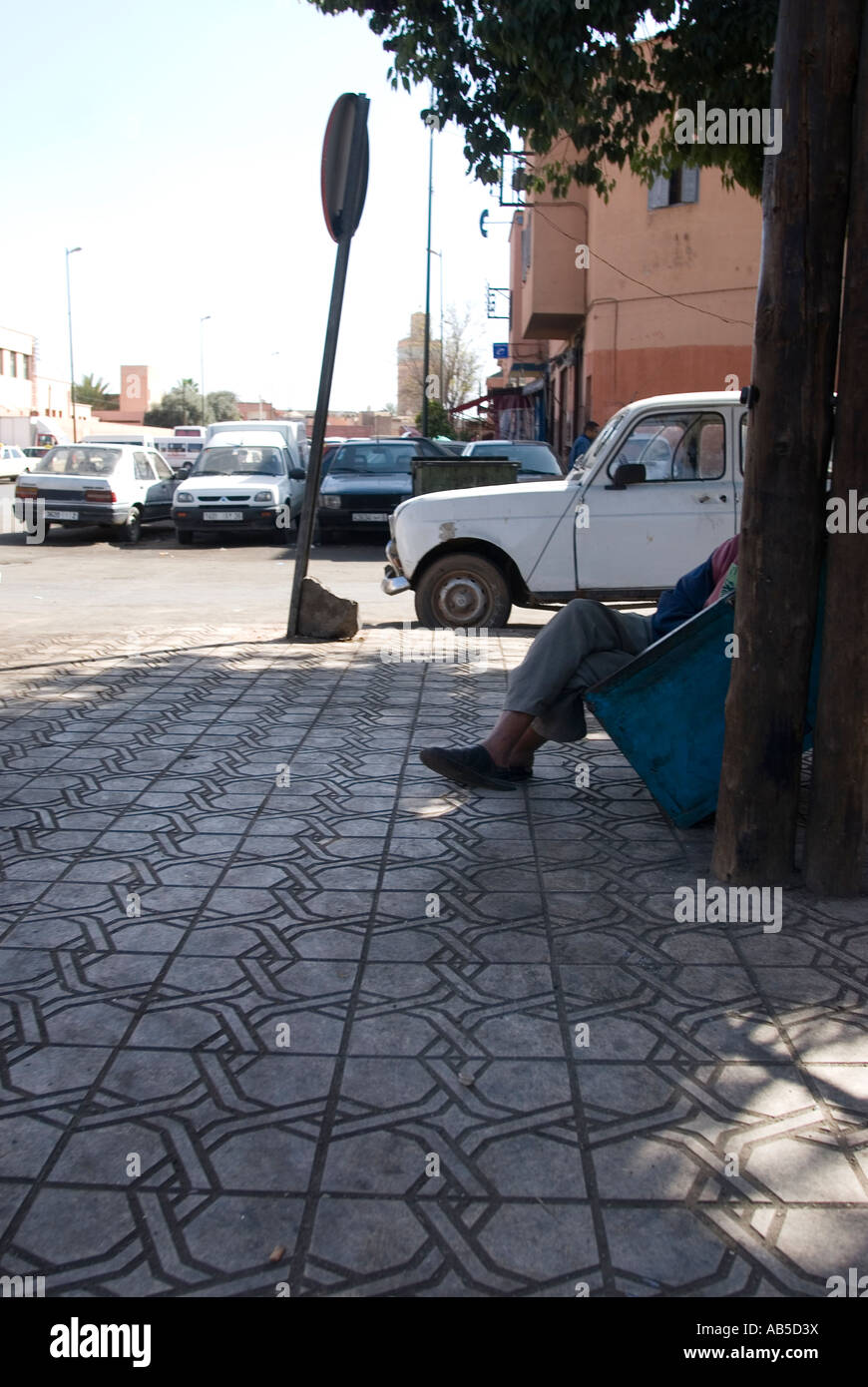 Man resting in blue loading cart on the street, Marrakesh, Morocco ...