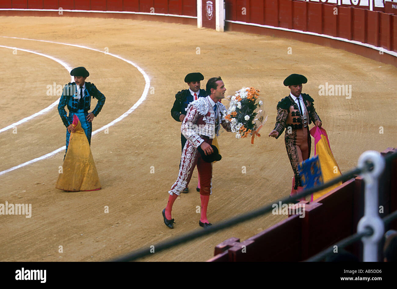 The Matador star bullfighter is thrown flowers by the cheering crowd ...