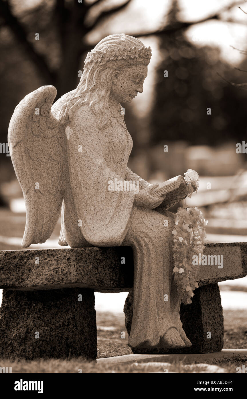 Sepia photo of a seated angel memorial in a cemetery Stock Photo - Alamy