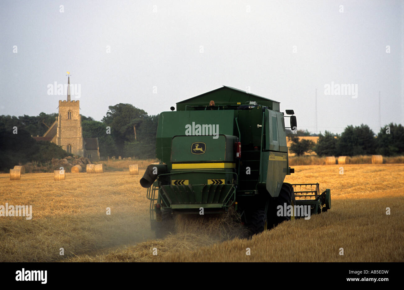 Combine harvester cutting wheat on a farm in Orford near Woodbridge ...